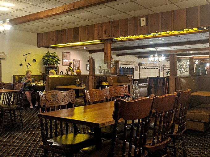 Those carved wooden chairs aren't trying to be trendy; they've earned their patina through decades of supporting happy diners. The dining room whispers "take your time" in the most reassuring way.