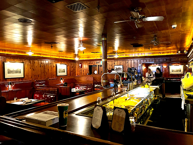The bar gleams with promise while wood-paneled booths stand ready for another evening of memorable meals and conversations.
