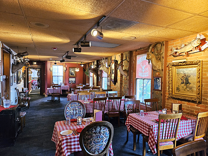 Red-checkered tablecloths beneath mounted trophies create a dining atmosphere that's equal parts hunting lodge, history museum, and comfort food sanctuary.