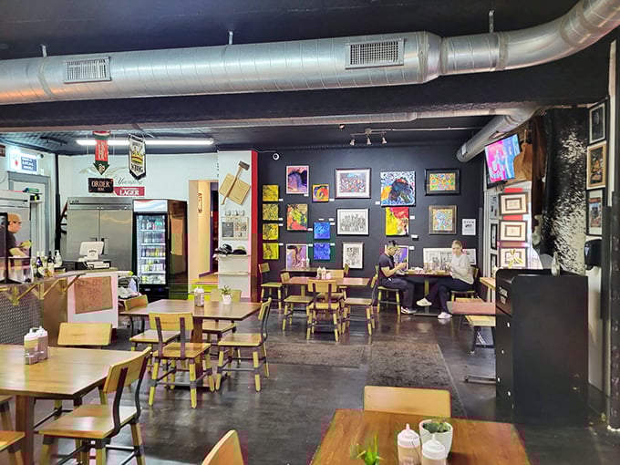 The dining area doubles as an art gallery, proving that beautiful things happen when creative minds and smoked meats share the same space.