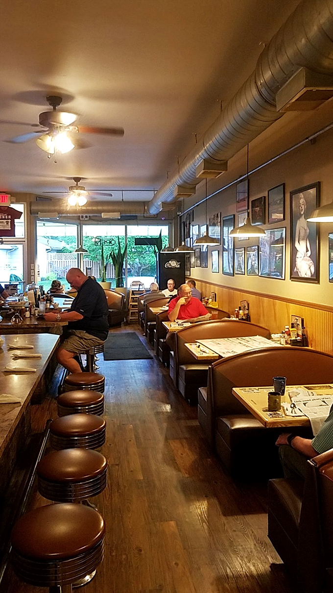 The dining area stretches back like a railroad car of breakfast dreams, with exposed ductwork above and decades of satisfied customers below.