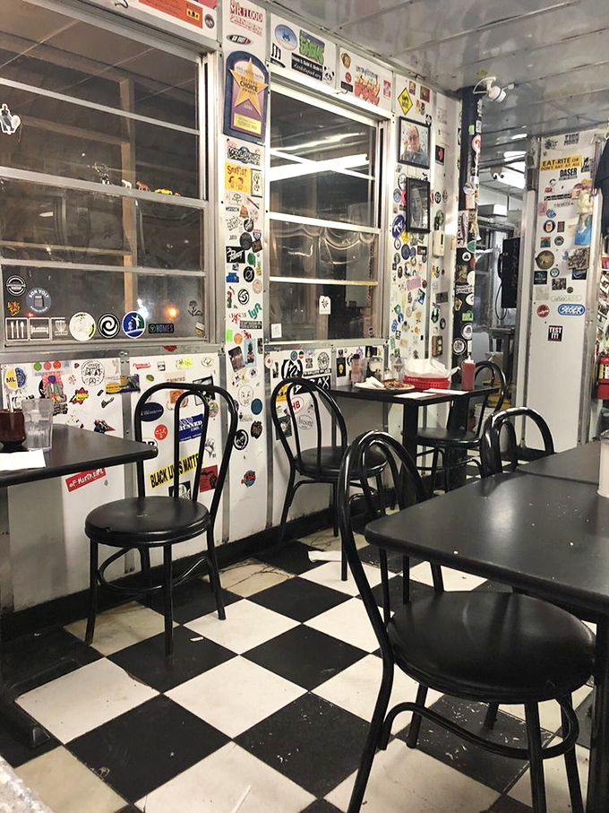 Black and white checkered floors anchor the space in diner tradition, while every wall surface tells stories of visitors past.