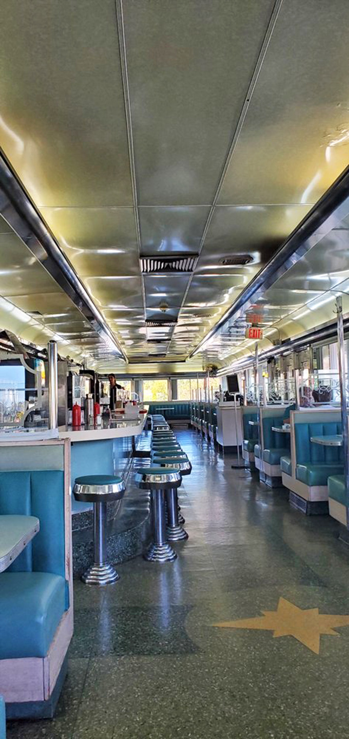 The diner's interior stretches like a gleaming silver bullet, with each booth offering its own little universe of possibility and pancakes.