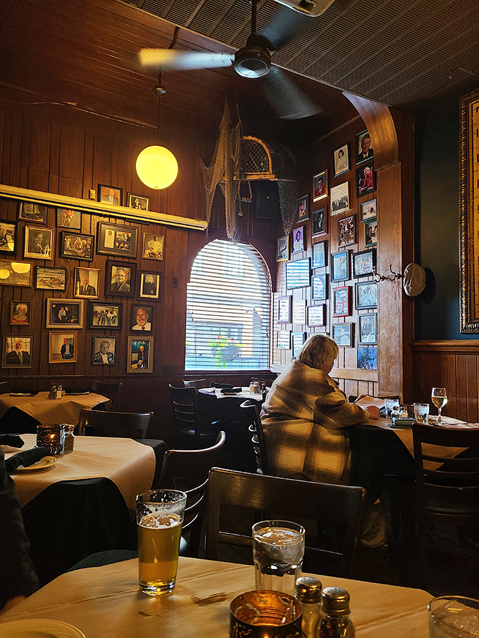 The wall of photographs tells stories of loyal patrons who've made this their second home for generations.