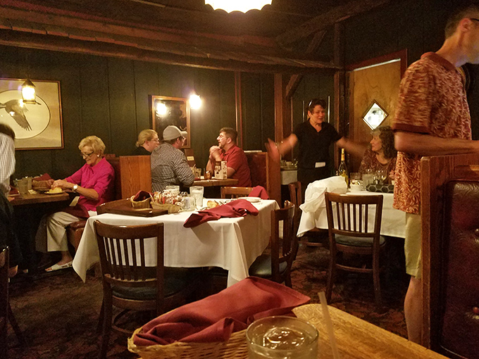 The dining area stretches like a narrow galley, with wood-paneled warmth that makes you feel like you're dining in the captain's quarters of a well-loved ship.