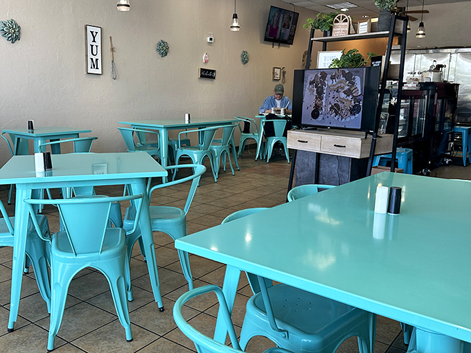The turquoise tables aren't just a design choice—they're an invitation to linger in a space that feels both modern and comfortingly familiar.