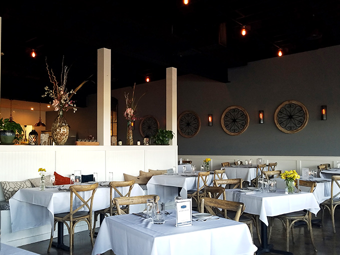 The dining room balances rustic and refined, where circular wall art echoes plates soon to be filled with deliciousness.