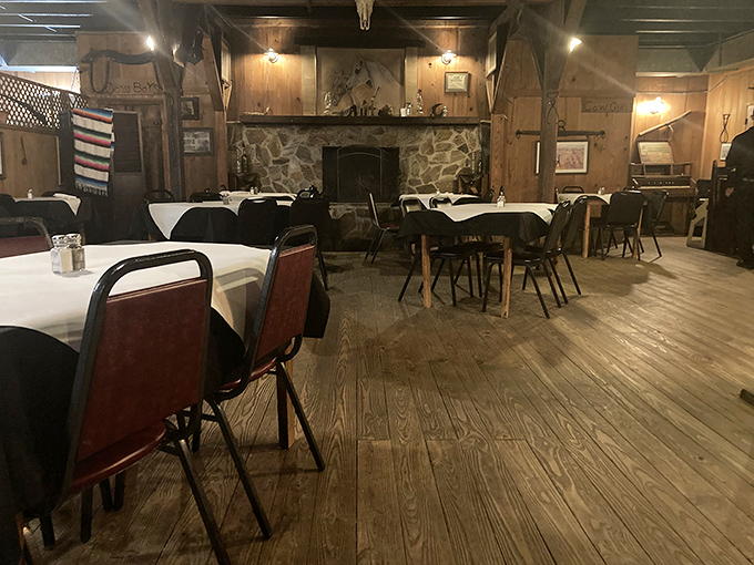 The dining room whispers stories of celebrations past, where wooden floors have supported generations of steak lovers beneath rustic beams.