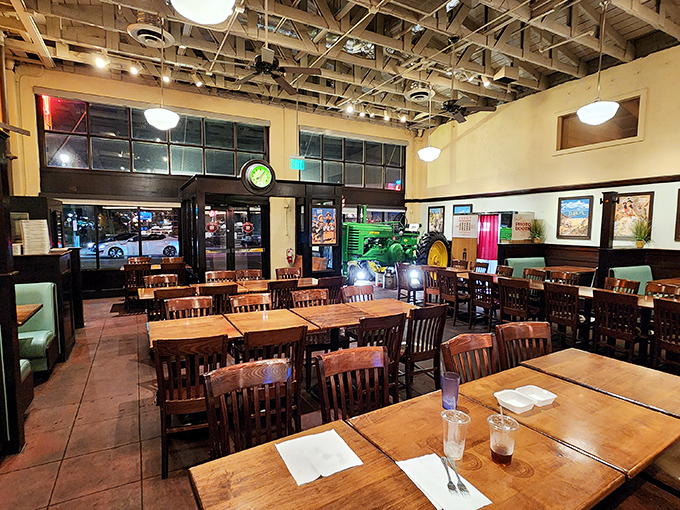 The dining room waits expectantly during off-hours, wooden chairs and exposed beams creating a temple of casual comfort.