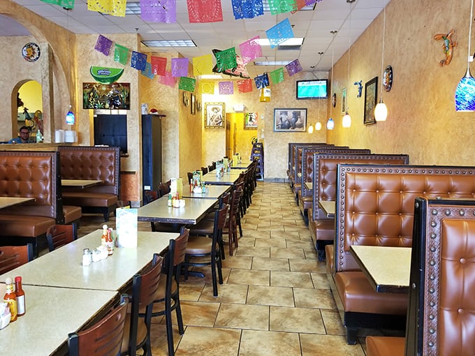 Papel picado banners flutter overhead like colorful guardians of good times, while leather booths stand ready for the serious business of feasting.