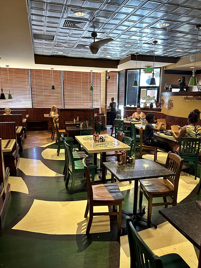 The dining room floor pattern swirls like the perfect pancake batter, guiding hungry patrons to tables where breakfast dreams come true.