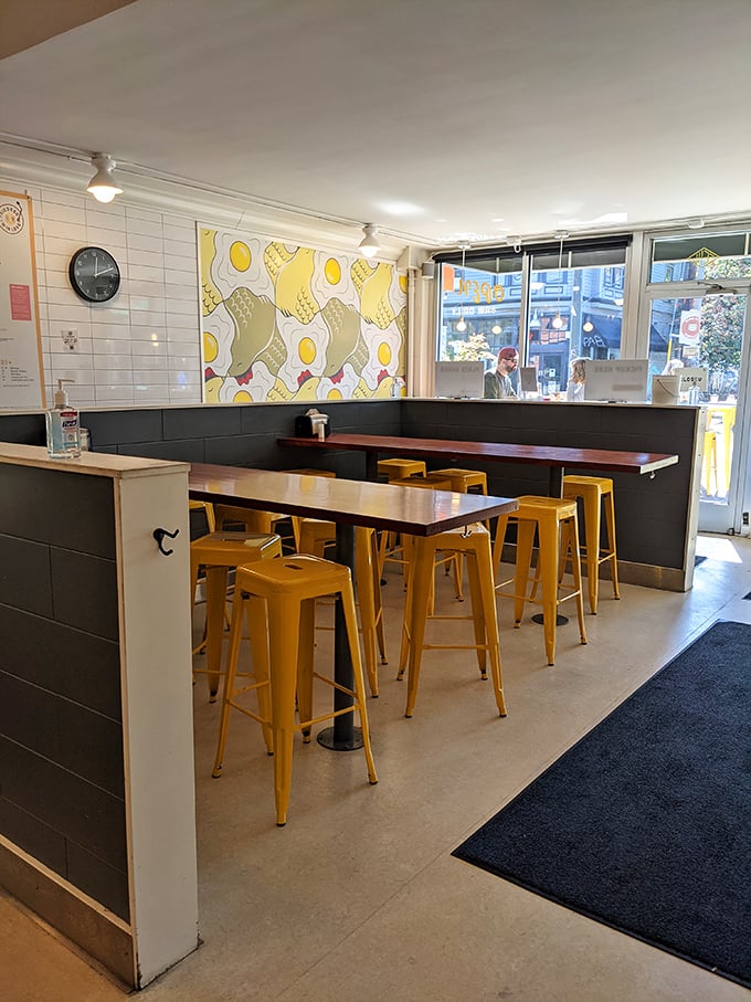 The dining area feels like breakfast's VIP section. Those yellow stools aren't just seats&mdash;they're front-row tickets to Portland's egg-rock concert.