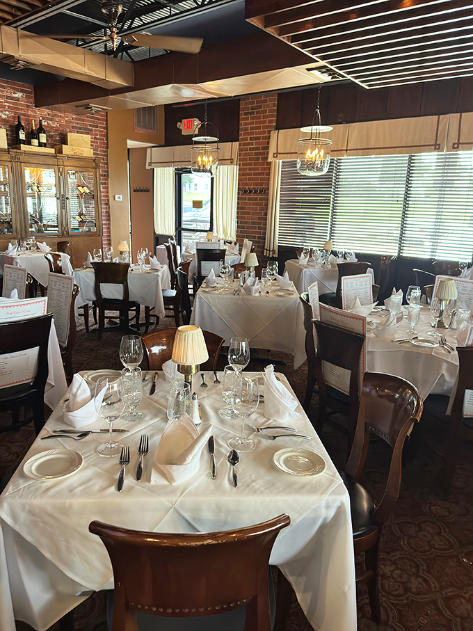 The dining room balances elegance and comfort, where white tablecloths say "special occasion" but the atmosphere whispers "come as you are."