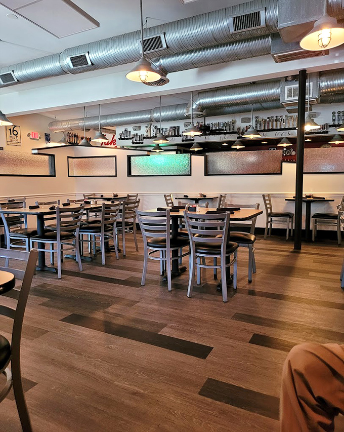 The dining area's industrial-chic ceiling ducts watch over wooden tables where countless burger dreams have been fulfilled.
