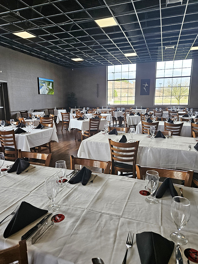 White tablecloths and wooden chairs create the perfect stage for meat theater. Each table awaits its starring role in your personal protein production.