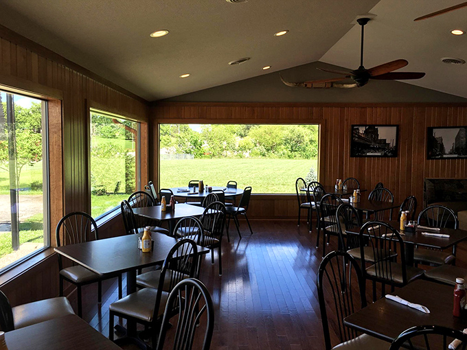 Large windows flood this dining area with natural light, turning an ordinary lunch into a sun-dappled retreat from the everyday.