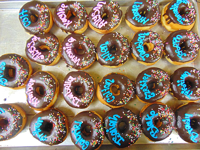 These aren't just donuts &ndash; they're personalized sugar bombs with names piped in festive icing, proving everything tastes better when it's made just for you.