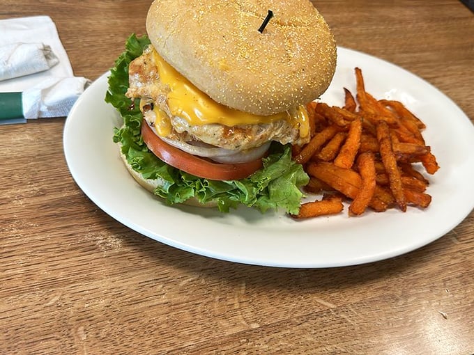 A burger that requires both hands and possibly a game plan. Those sweet potato fries aren't just sides&mdash;they're supporting actors deserving their own award.