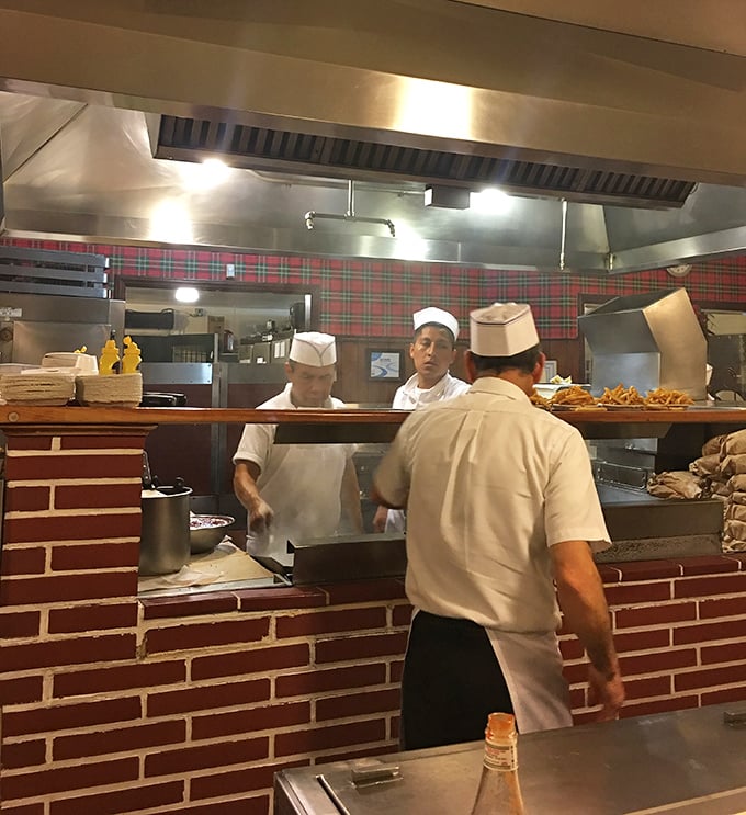 The white-uniformed crew works with the precision of symphony musicians, flipping burgers and serving slices of pie with practiced efficiency.