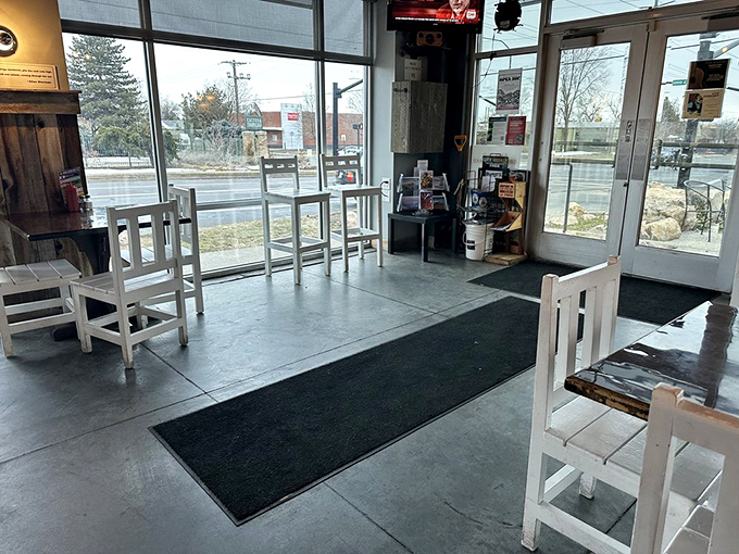 The entrance beckons with minimalist charm&mdash;concrete floors and white chairs saying, "Come in, we're serious about sandwiches, not d&eacute;cor."