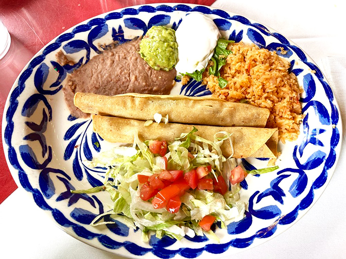 Flautas de Pollo served with a garden of fresh garnishes&mdash;crispy rolled tacos standing at attention, ready to report for delicious duty.