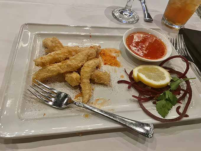 Calamari so lightly fried it defies gravity. The marinara sauce waits patiently for its moment of tangy glory.