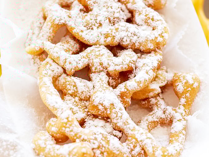 Powdered sugar snowdrifts on golden-fried dough ribbons. Del Rancho's funnel cake brings state fair delights to everyday life.