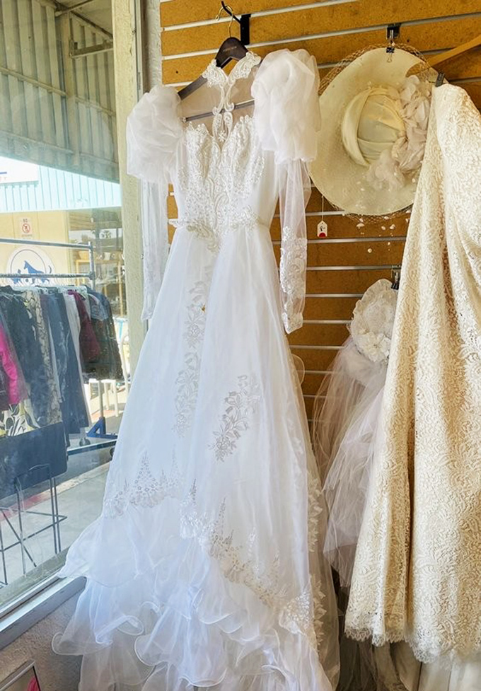 Wedding gowns with second-chance romance potential hang like elegant ghosts, waiting to make another bride's budget-friendly dreams come true.