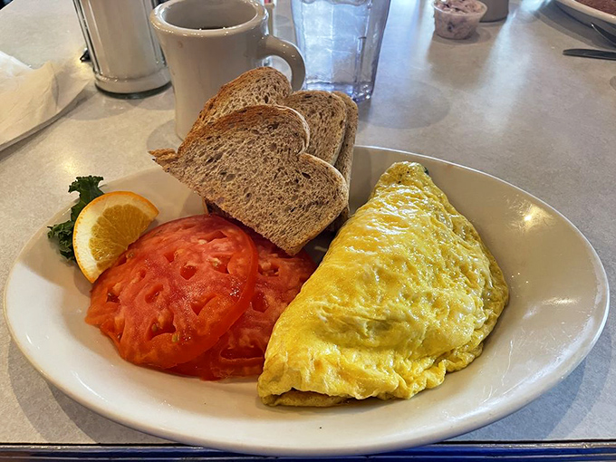 An omelet so perfectly executed it deserves its own spotlight, accompanied by toast that's achieved that elusive perfect golden-brown.