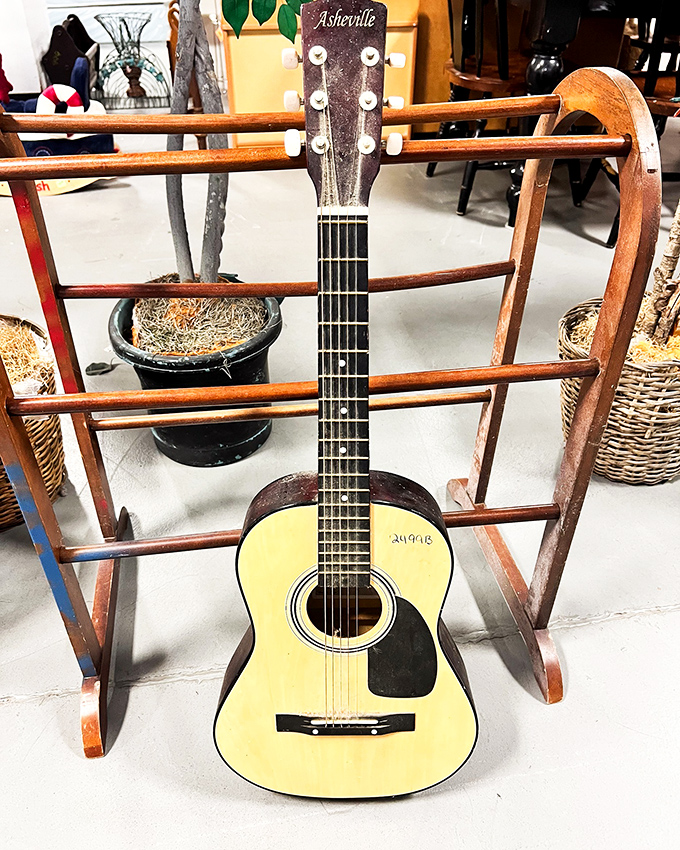 This Asheville-branded acoustic guitar isn't just an instrument—it's someone's musical journey waiting for its next chapter.
