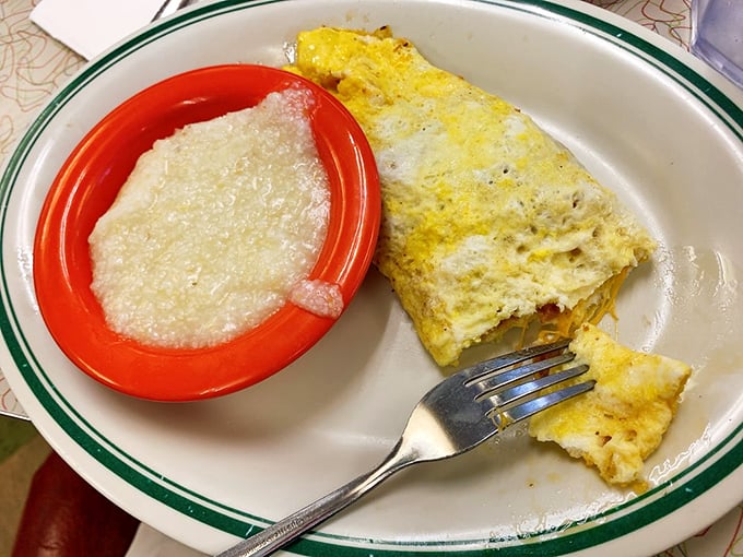 The perfect omelet doesn't exi&mdash; Oh wait, here it is, lounging beside a bowl of grits like they're on vacation in flavor country.