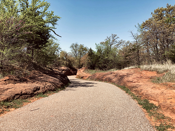 Highland Park's winding trail cuts through red rock formations, proving Oklahoma's natural beauty can be just as captivating as its architectural treasures.