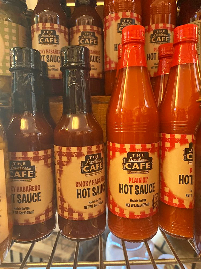 Hot sauce bottles lined up like soldiers ready for delicious battle. The checkered labels are a warning: Tennessee heat comes in many forms.