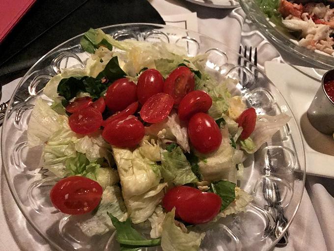 Even the house salad gets the white tablecloth treatment here. Those cherry tomatoes are dressed better than most people at the mall.