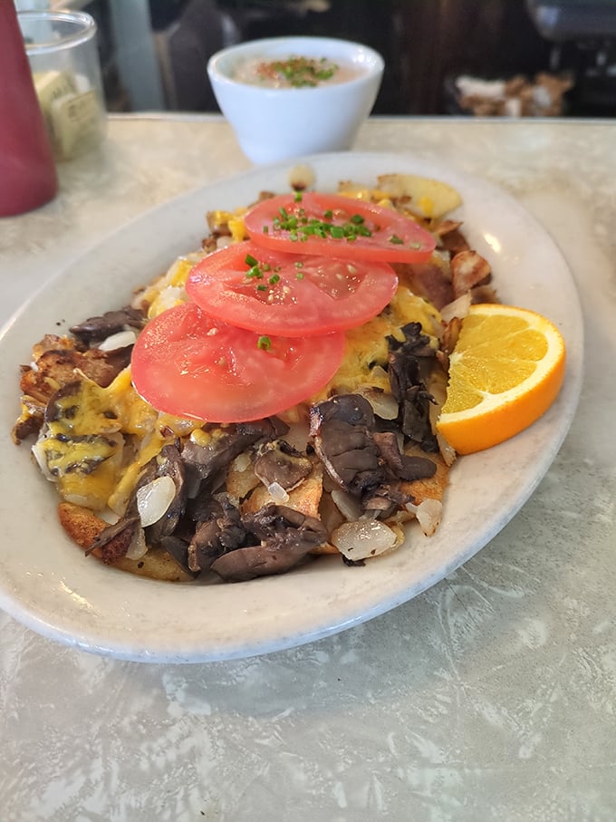 A mountain range of potatoes, mushrooms, and cheese topped with tomato slices like sunset-colored clouds&mdash;this breakfast knows how to make an entrance.