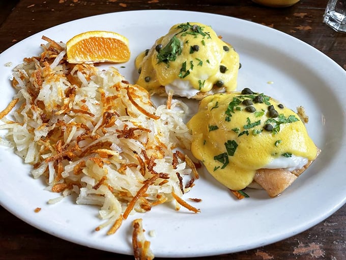 Eggs Benedict: where hollandaise sauce flows like liquid gold over poached eggs perched on English muffins, with hash browns crisped to perfection.