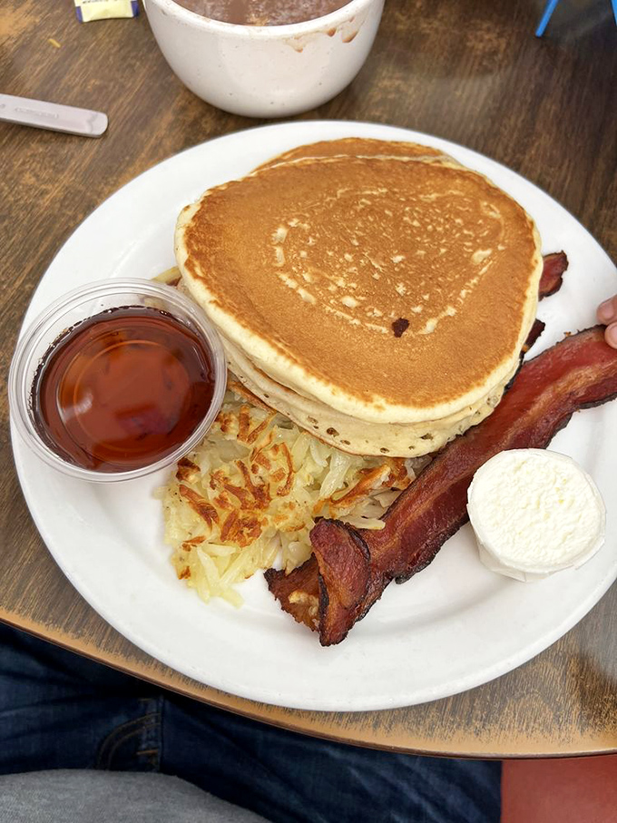 A breakfast plate that proves pancakes can be both art and science &ndash; perfectly round, golden, and capable of making Monday mornings bearable.