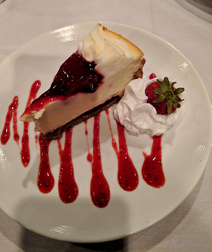 This isn't just cheesecake&mdash;it's a sweet finale worthy of a standing ovation, with berry sauce adding dramatic flair to each bite.