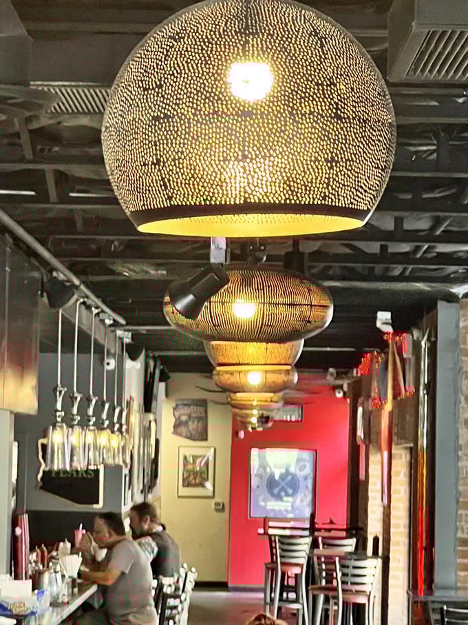 Artisanal lighting fixtures dangle from the ceiling like modern art installations, setting the perfect mood for serious burger contemplation.