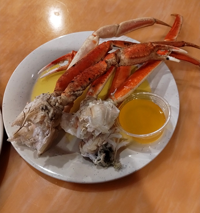 Crab legs positioned like trophy antlers, with clarified butter standing by for the victory dip.