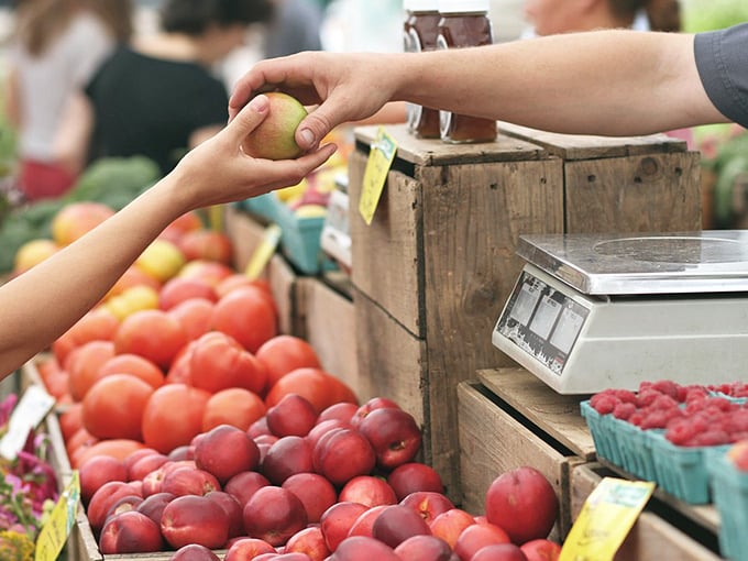 At Sulphur's farmers market, the simple exchange of an apple becomes a connection to the land and the people who tend it with care.