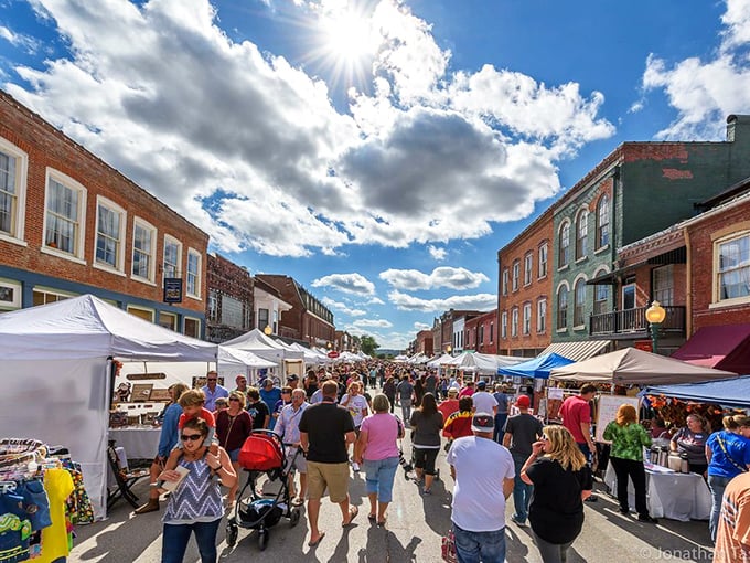 Festival days transform Main Street into a bustling marketplace. Locals and visitors mingle between white tents, hunting treasures and sampling local fare.