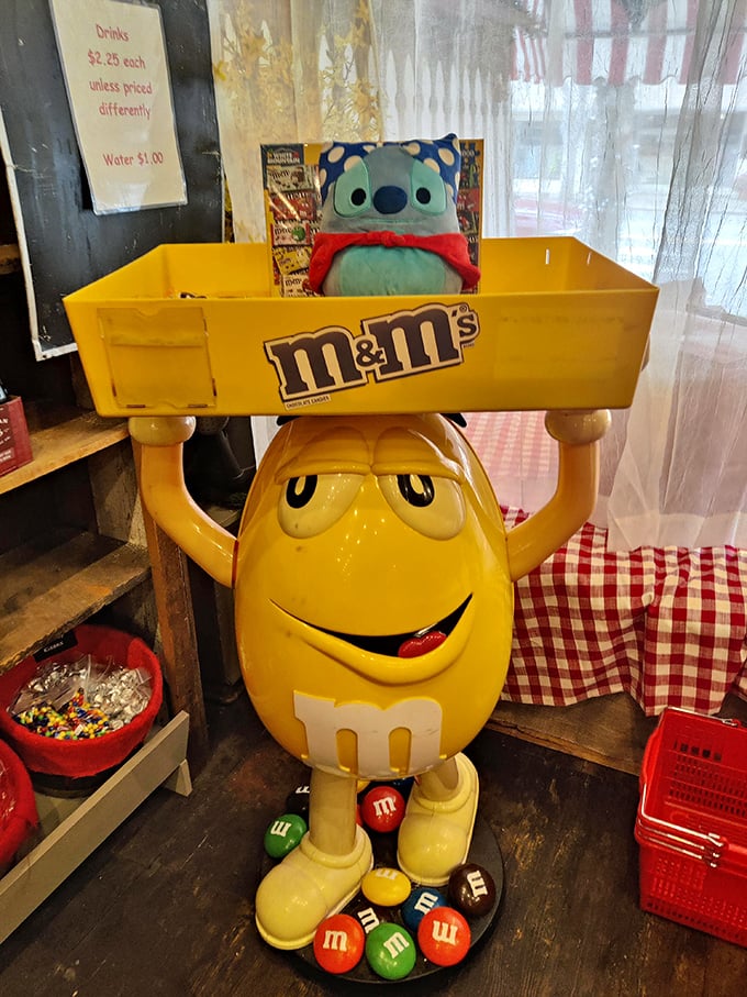 The yellow M&M stands guard, silently judging your candy selections while somehow encouraging you to make increasingly indulgent choices.
