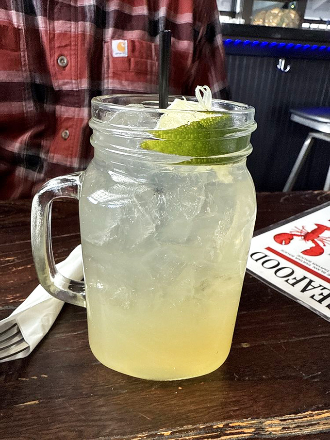 Even the drinks come in mason jars, because nothing says "authentic New England seafood experience" like sipping lime-garnished refreshment from glassware your grandmother pickled in.