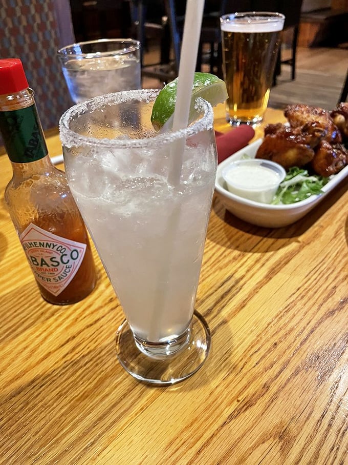 A margarita with salt-rimmed perfection sitting beside what appears to be wings&mdash;proof that some combinations are simply ordained by the universe.