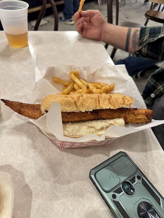 The sandwich that requires both hands and a plan. This monster fish creation is what happens when "just enough" isn't in the vocabulary.