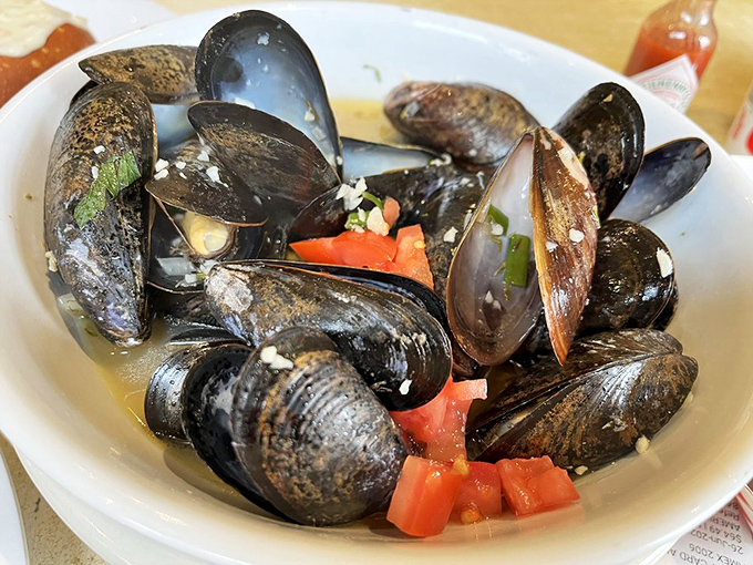 These mussels aren't just opened, they're having a full-on conversation with tomatoes and herbs in a steamy broth hot tub.