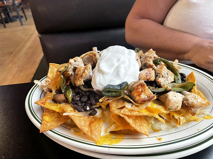 These nachos don't mess around&mdash;loaded with chicken, beans, and a dollop of sour cream that melts into the warm chips below. Sharing is technically optional.