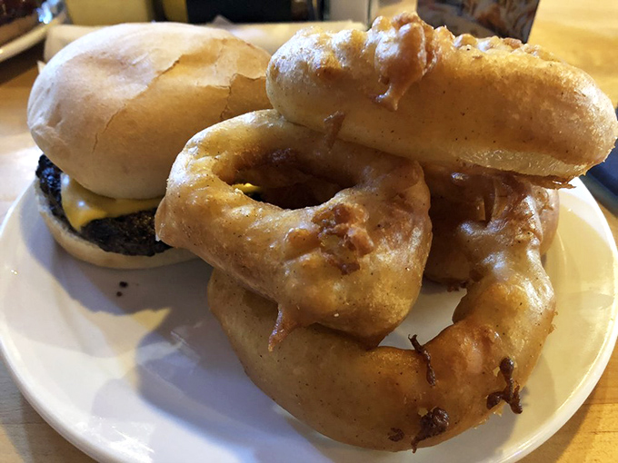 Onion rings so perfectly golden and crisp they deserve their own Instagram account. That dipping sauce isn't optional—it's essential happiness.