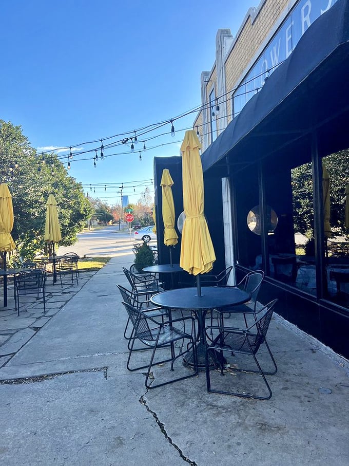 Patio seating where string lights create instant ambiance. Those yellow umbrellas aren't just for shade&mdash;they're setting the stage for memorable meals.